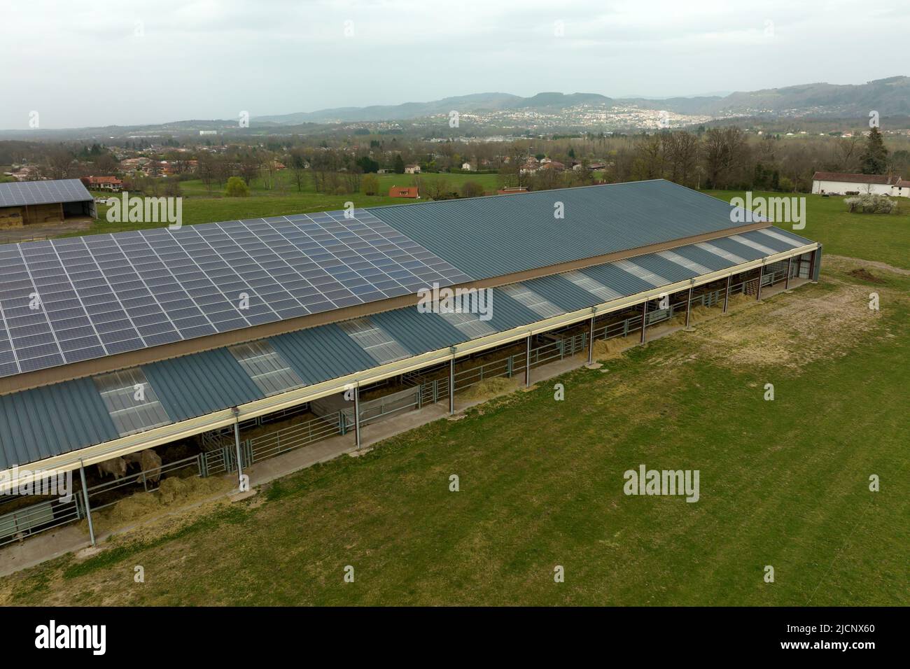 Aerial view of farm building with photovoltaic solar panels mounted on ...