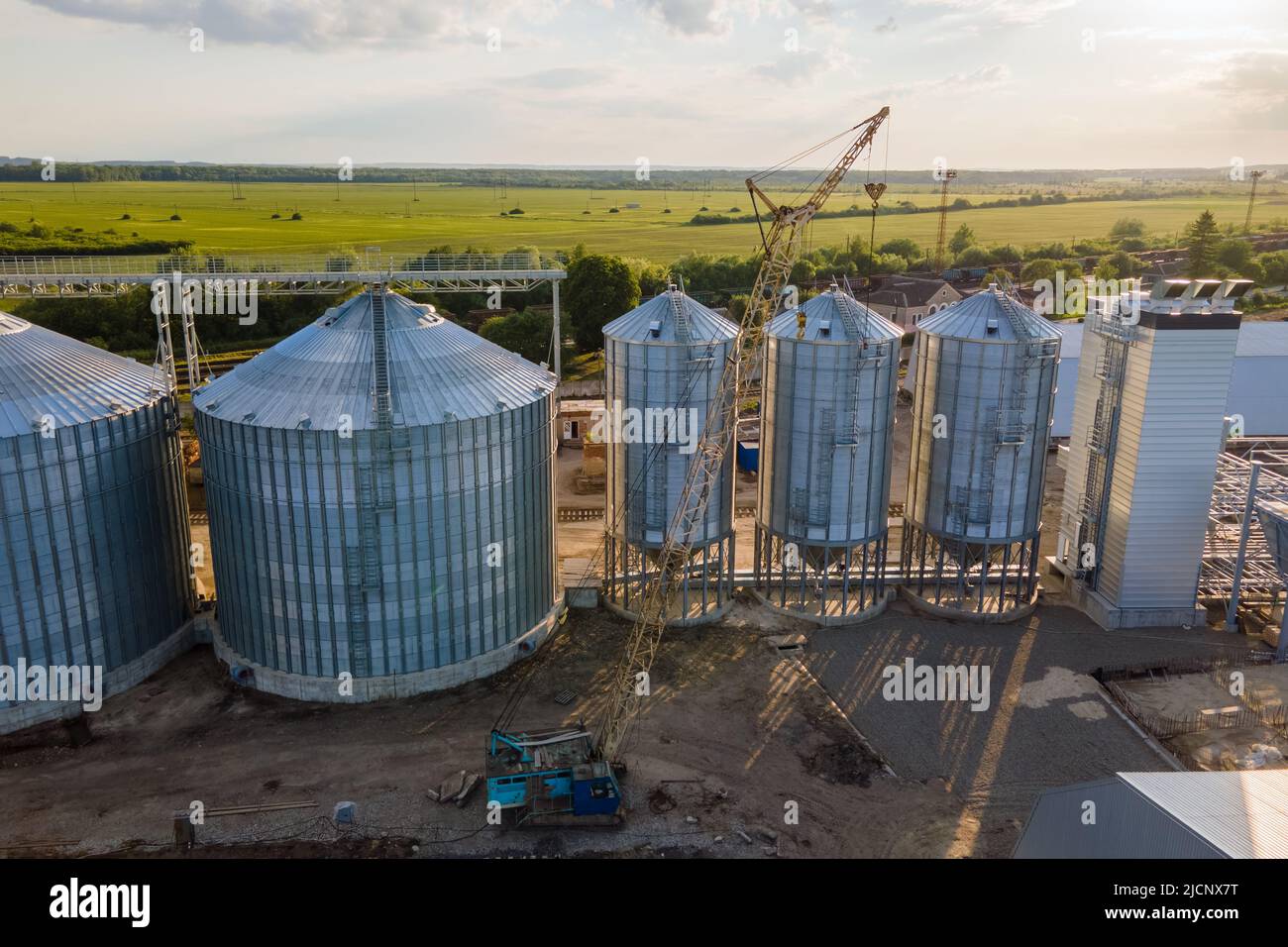 Aerial view of industrial ventilated silos for long term storage of grain and oilseed. Metal ...