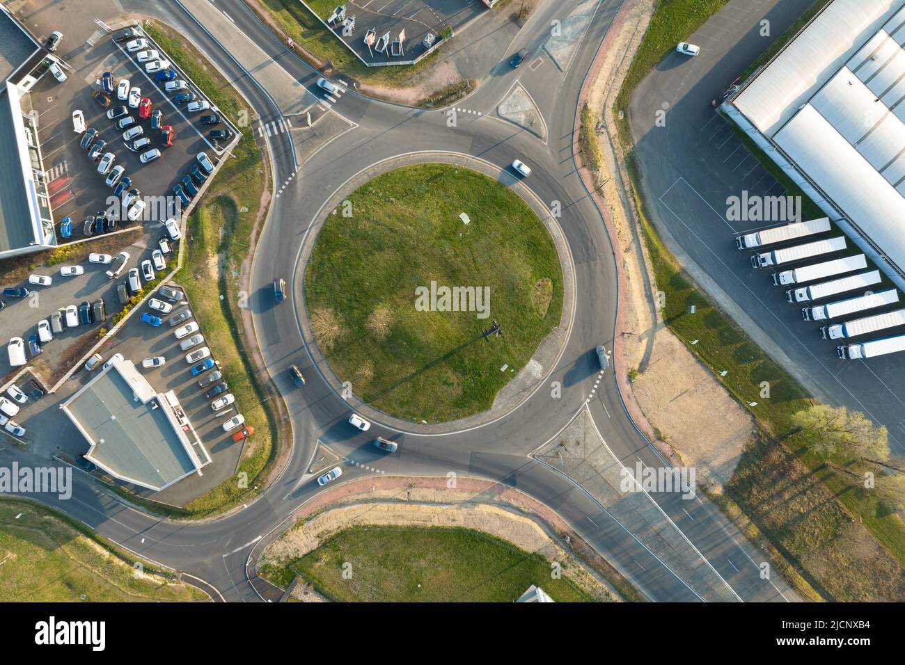 Aerial view of road roundabout intersection with moving heavy traffic. Urban circular ...