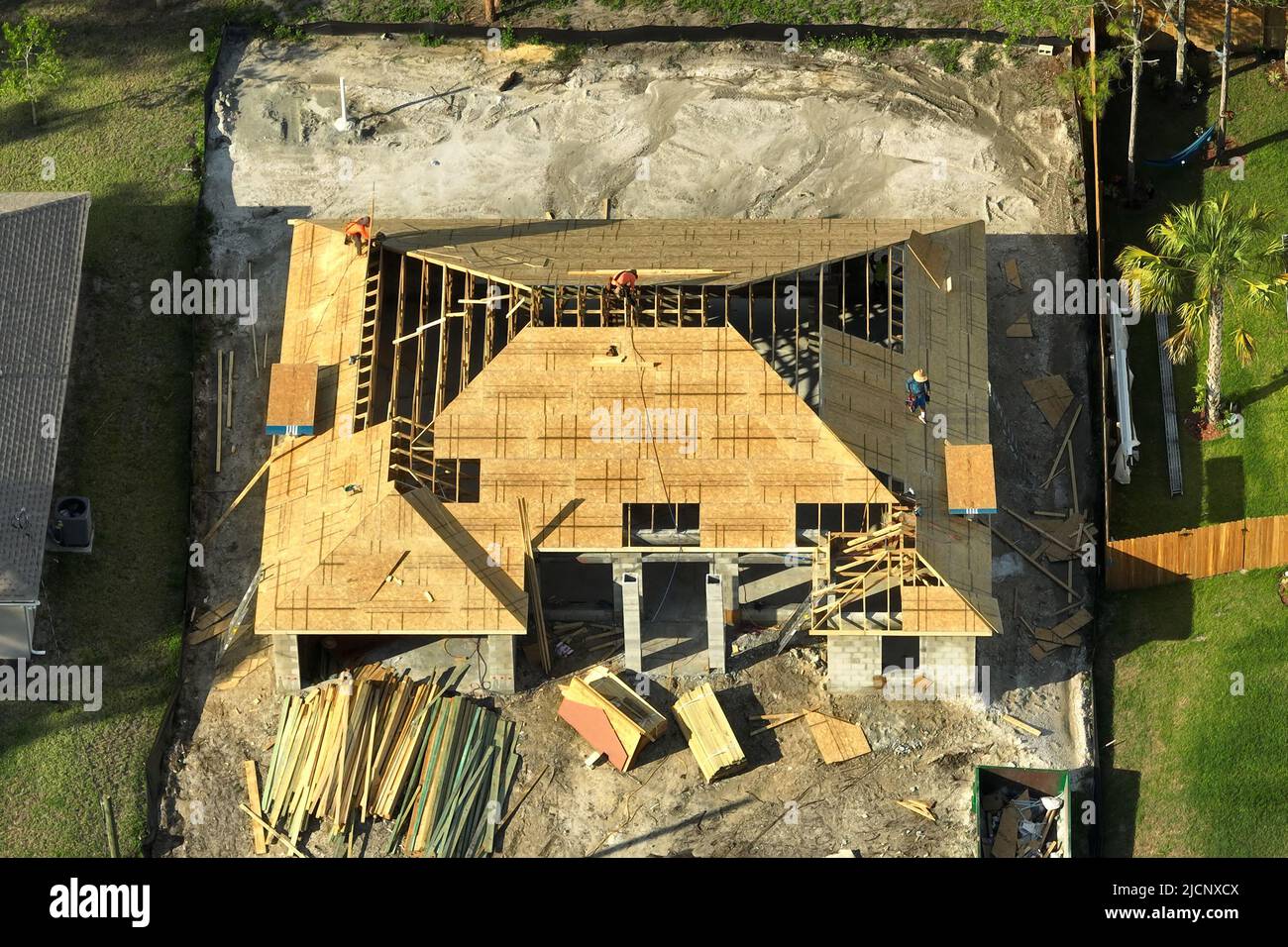 Aerial view of suburban private house wit wooden roof frame under ...