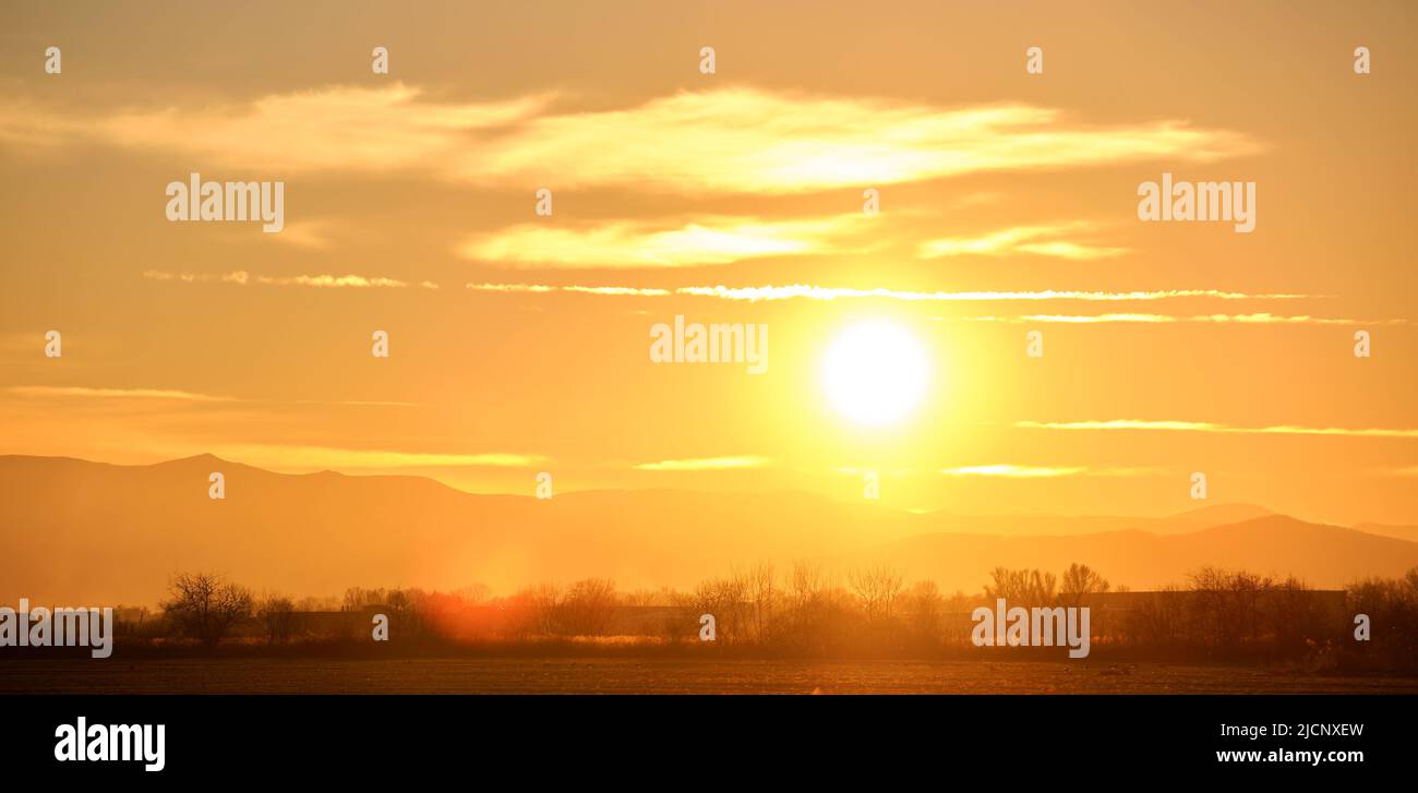 Beautiful evening panoramic landscape with bright setting sun over ...