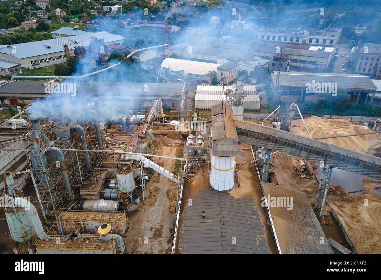 Aerial view of wood processing plant with smokestack from production ...