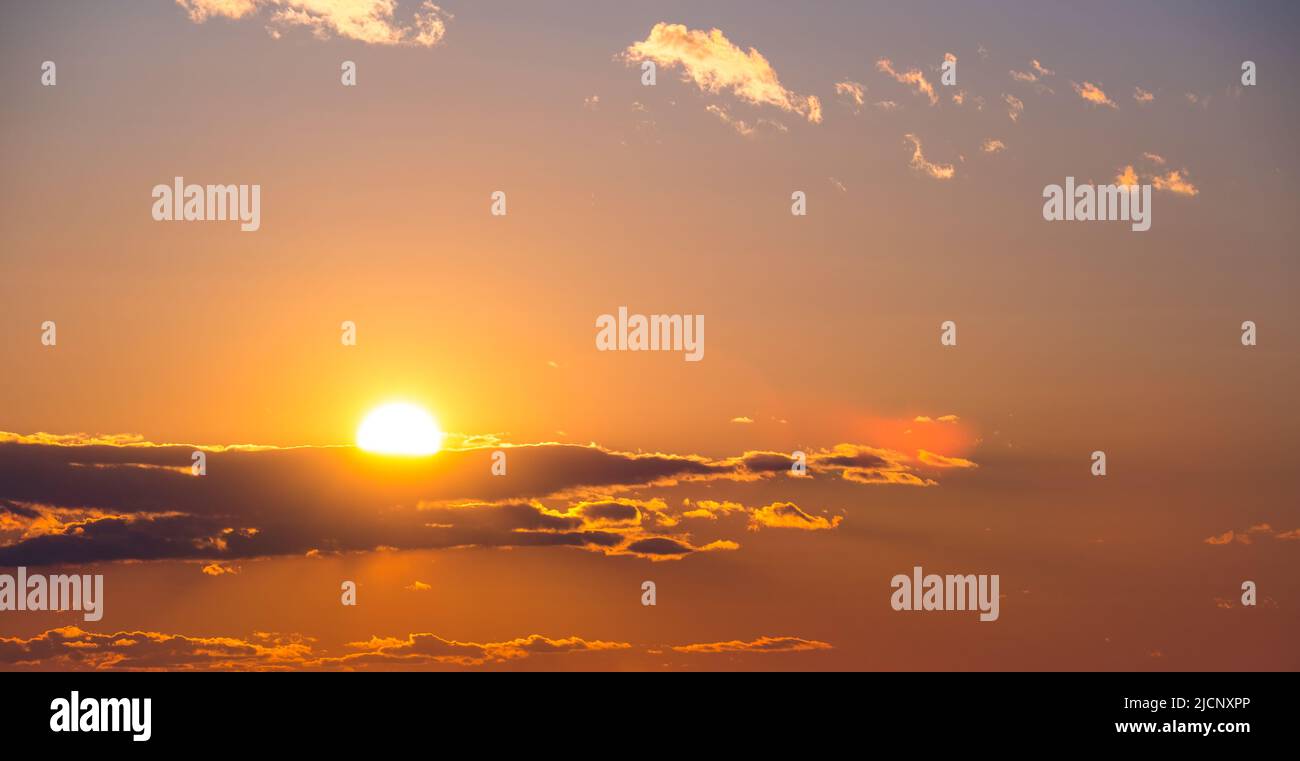 Bright colorful sunset sky with rays of setting sun and vivid dark ...