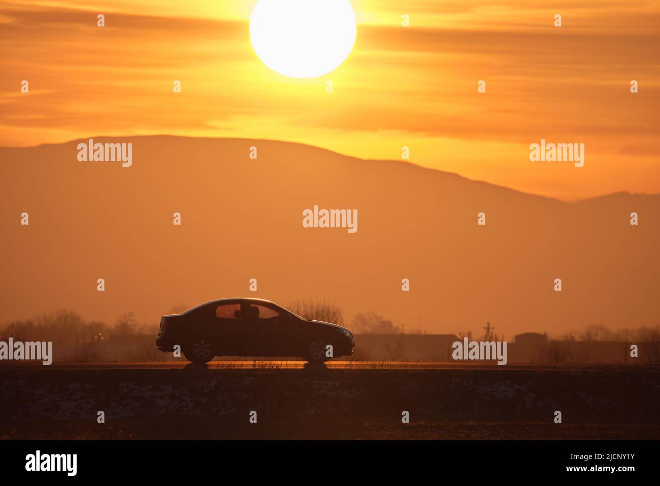 Car driving fast on intercity road at sunset. Highway traffic in ...