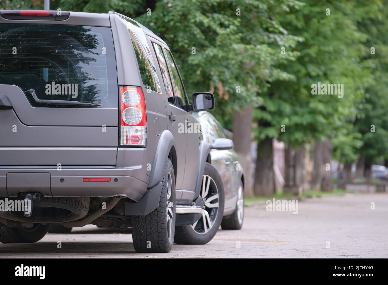 Close up of a car parked on city street side. Urban traffic concept ...