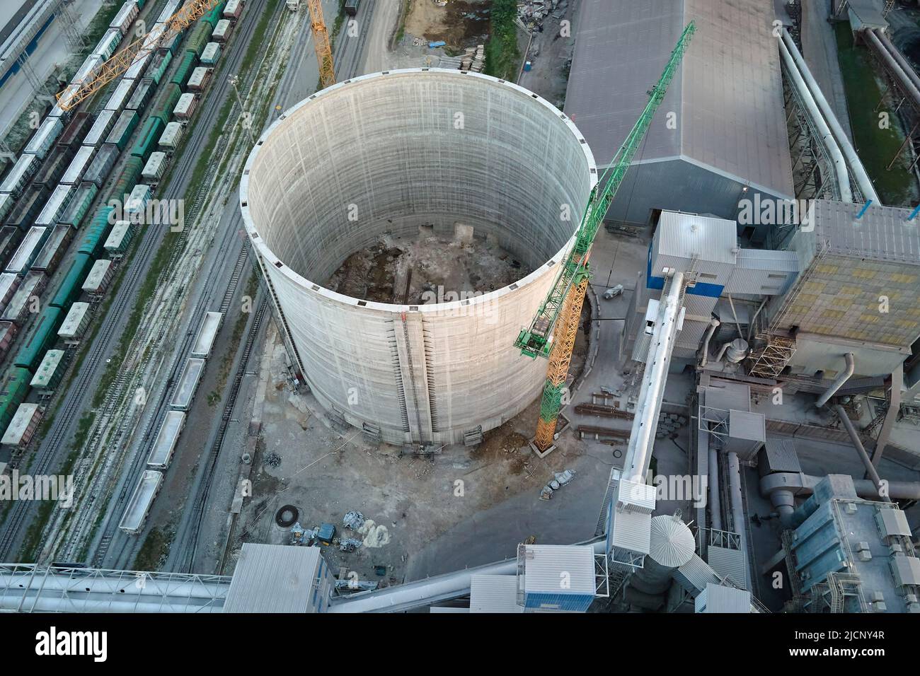 Cement plant with high factory structure and tower cranes at industrial ...