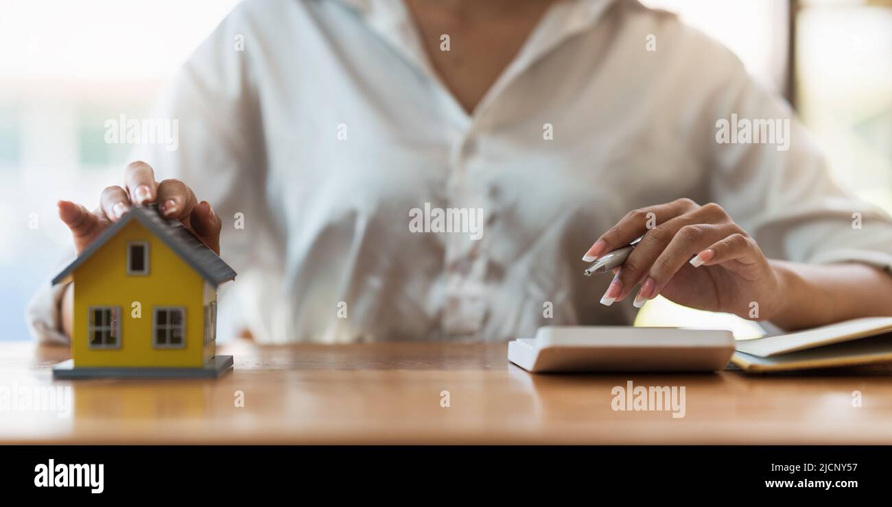 A woman holding and checking house model .Real Estate House Appraisal ...