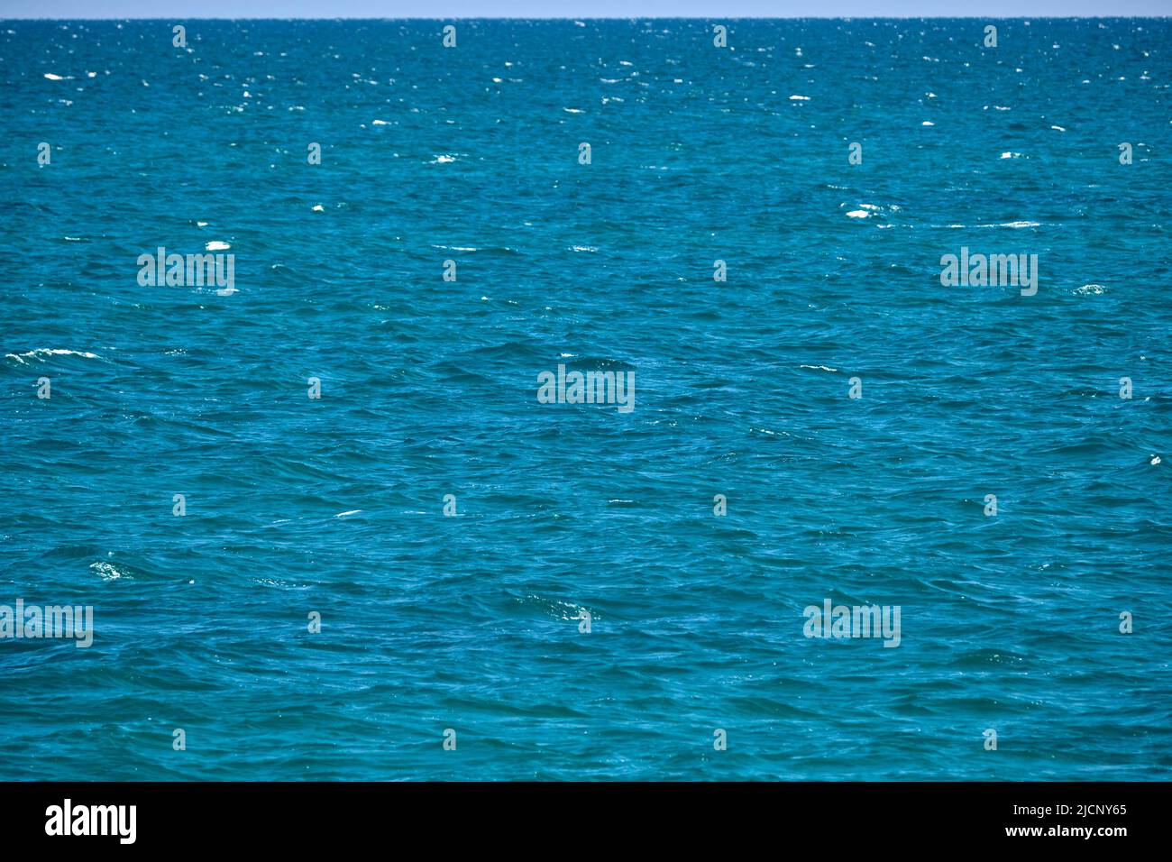 Closeup seascape surface of blue sea water with small ripple waves ...