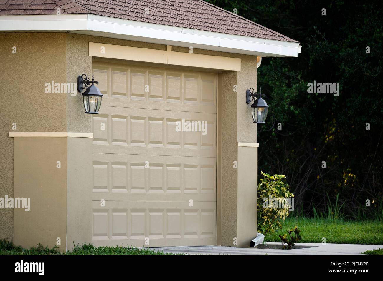 Wide garage double door and concrete driveway of new modern american ...