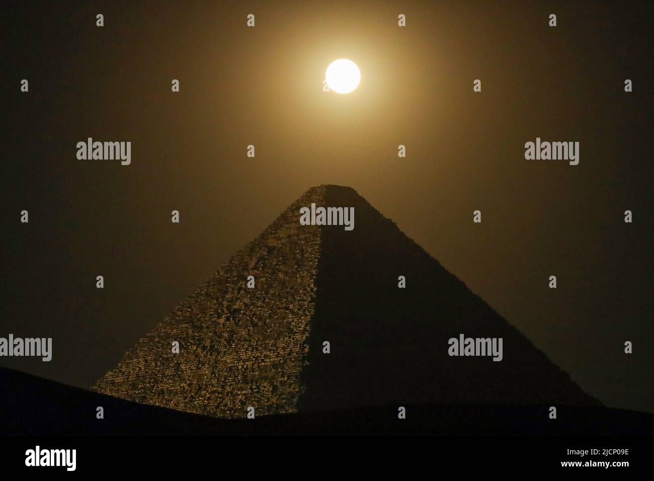 Cairo, Egypt. 14th June, 2022. A supermoon is seen in the sky over the ...