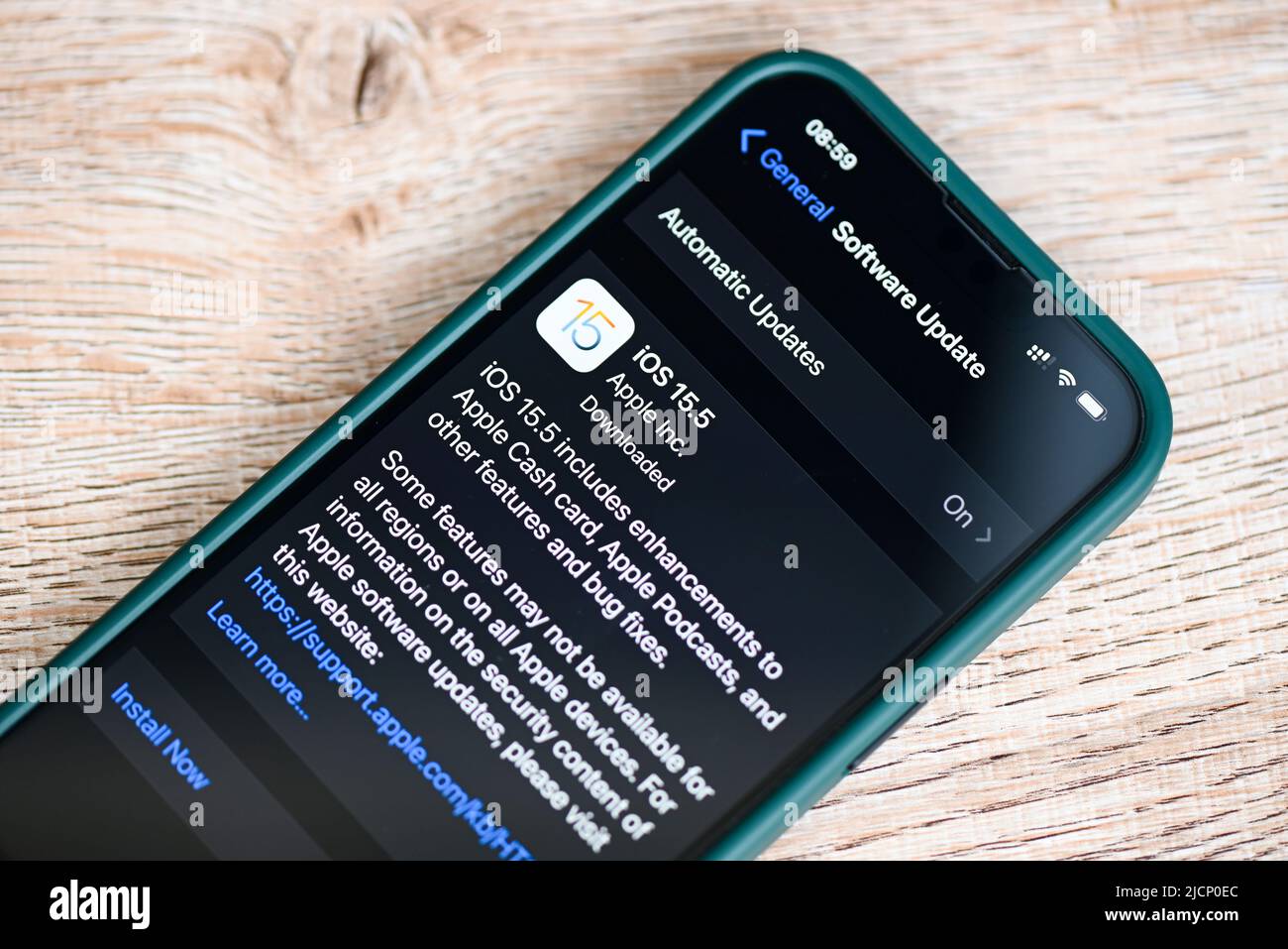 iPhone 13 Pro with iOS 15.5 logo on the screen close up, new operating ...