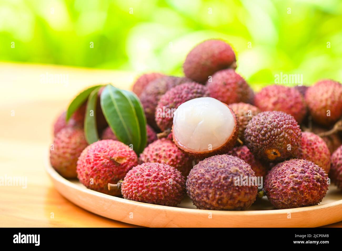 Lychee frui with green leaf on wooden plate background , fresh ripe ...
