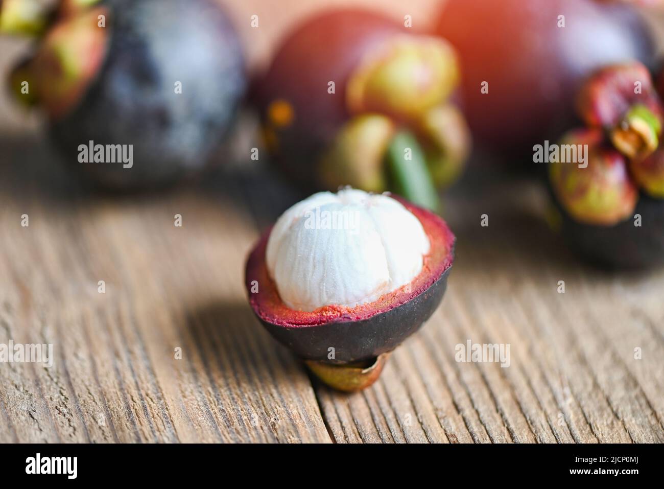 Mangosteen on wooden background, fresh ripe mangosteen peeled from tree ...