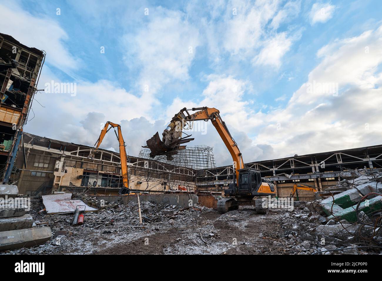 Demolition of old industrial building by huge excavator Stock Photo - Alamy