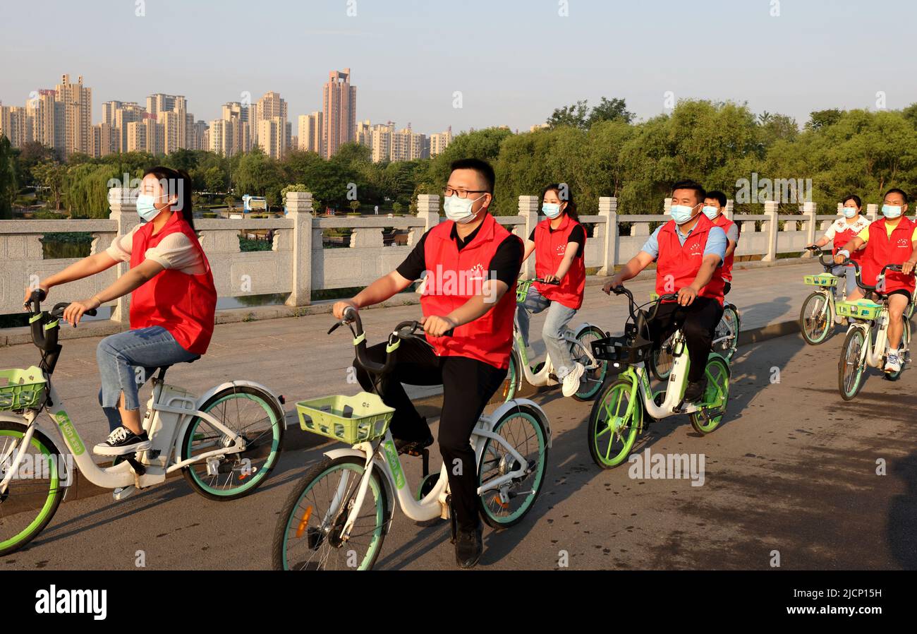 ZAOZHUANG, CHINA - JUNE 15, 2022 - Volunteers ride shared bikes in ...