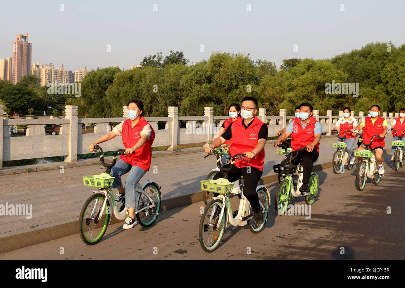 ZAOZHUANG, CHINA - JUNE 15, 2022 - Volunteers ride shared bikes in ...