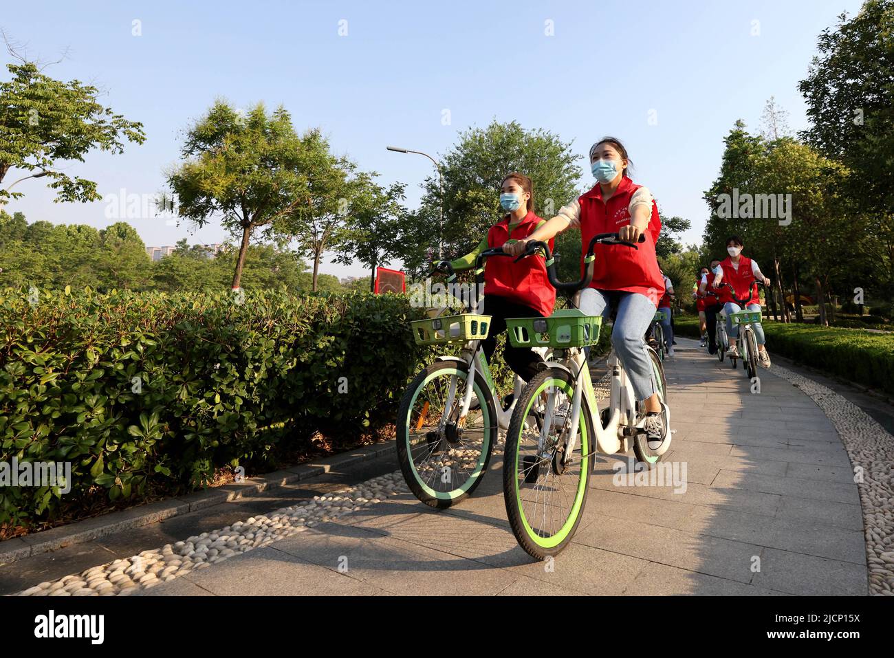 ZAOZHUANG, CHINA - JUNE 15, 2022 - Volunteers ride shared bikes in ...