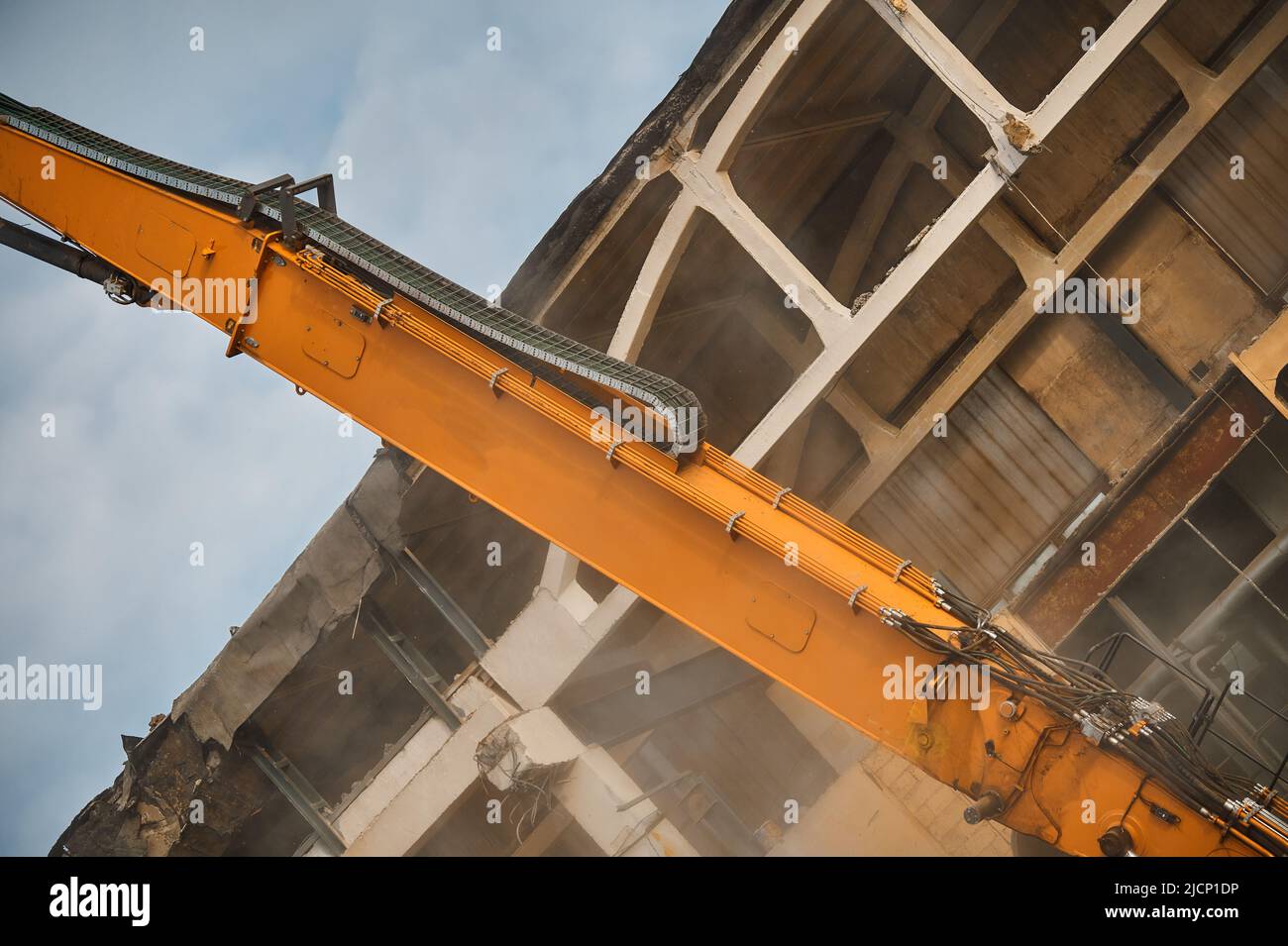 Hydraulic scissors on rig of crane cut building on site Stock Photo - Alamy