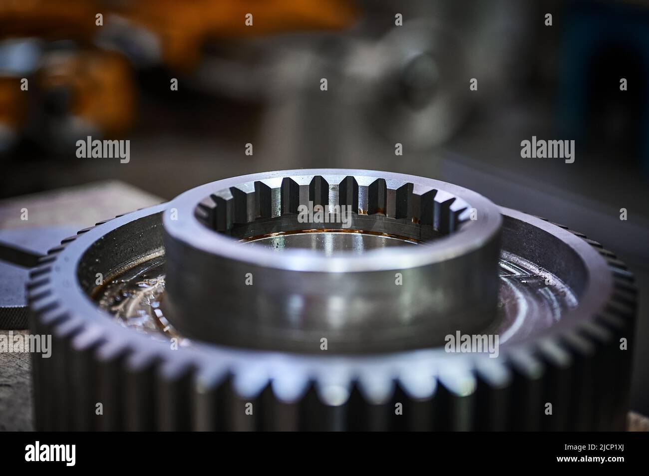 Pile of metal cogwheels for spiral gear drive in warehouse Stock Photo ...