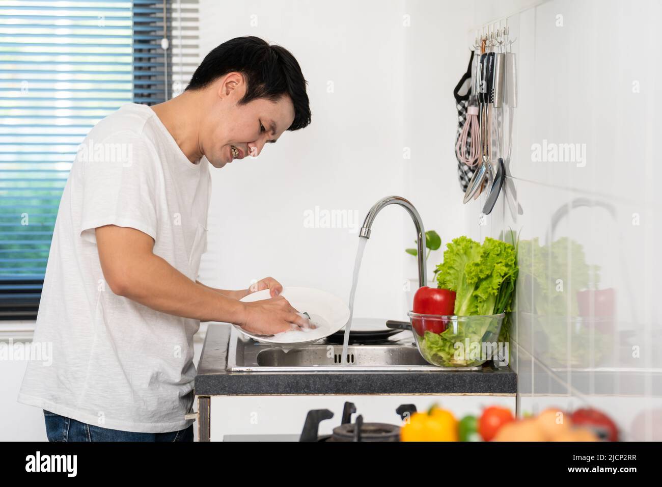 Male washing the dishes hi-res stock photography and images - Alamy