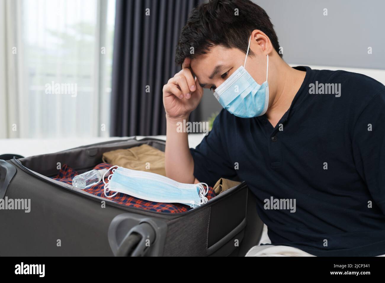 stress man with face mask packing suitcase luggage protect coronavirus ...