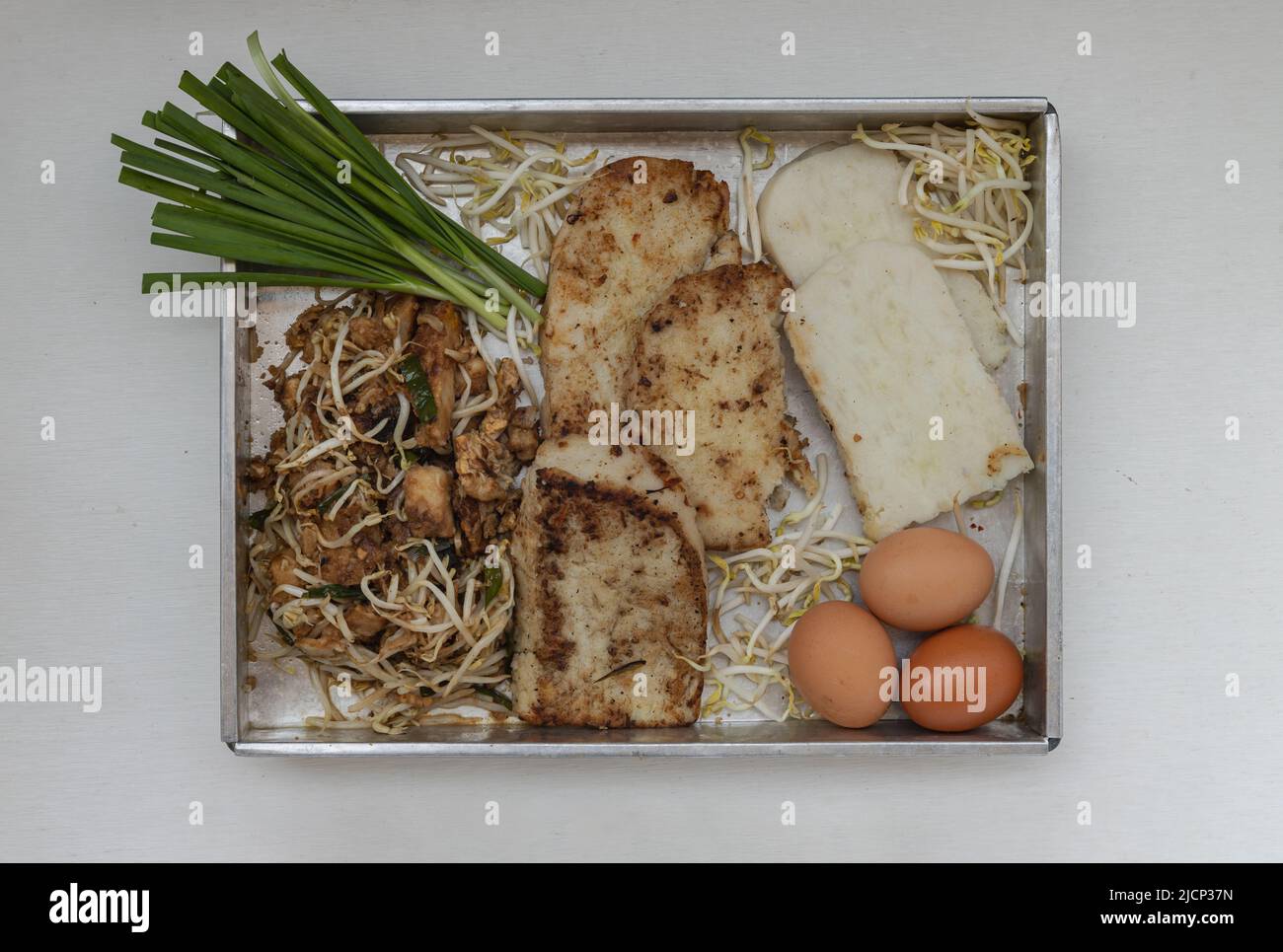 Stir-fried soft turnip cake or Fried radish cake (chai tow kway) with ...