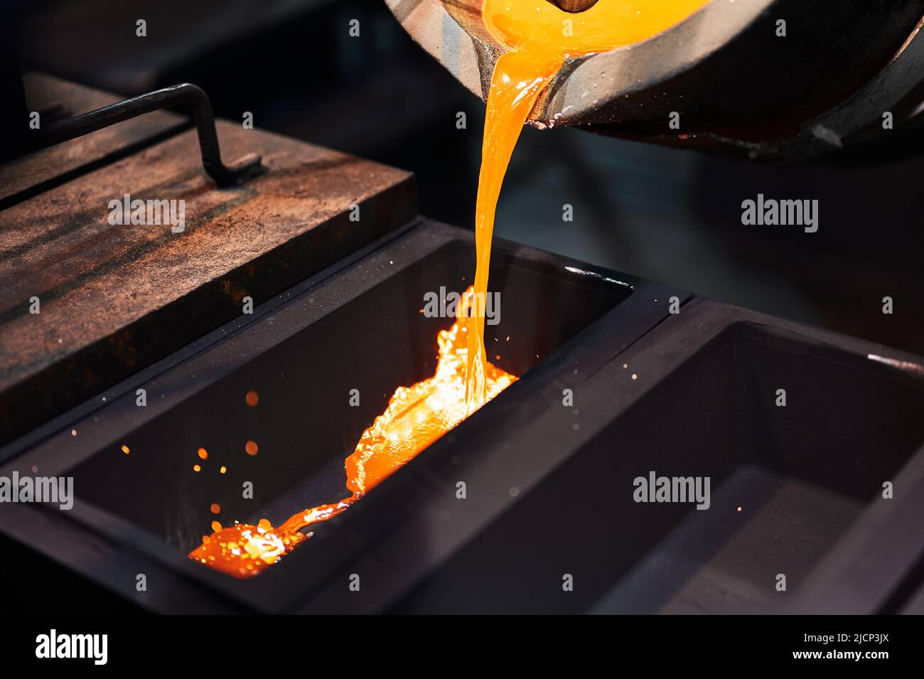 Molten silver is poured from a small ladle Stock Photo - Alamy