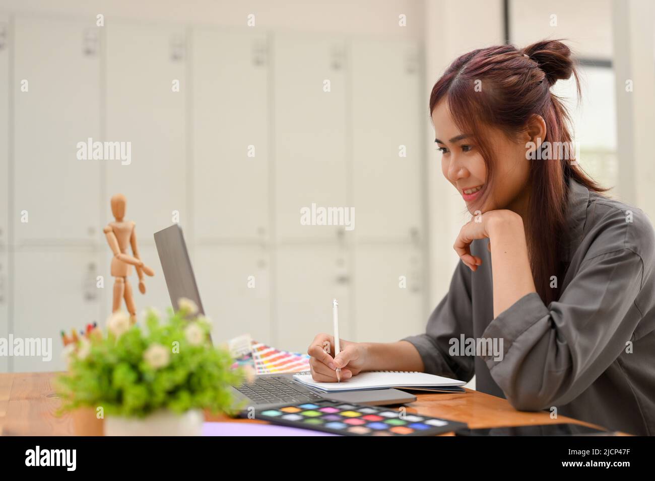 Creative young asian female graphic designer using laptop computer ...