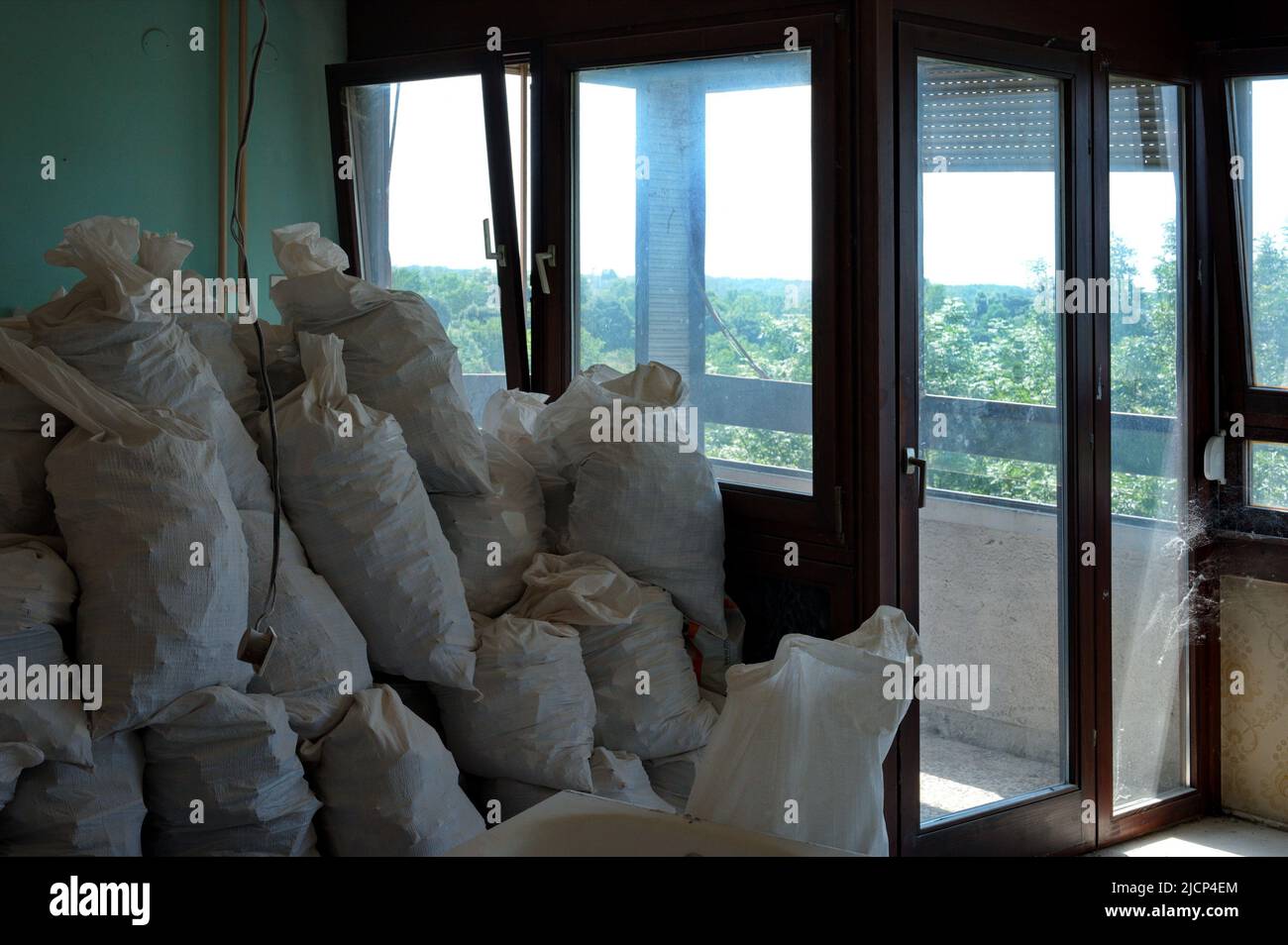 Garbage sack bags with pieces of destroyed wall in apartment under ...