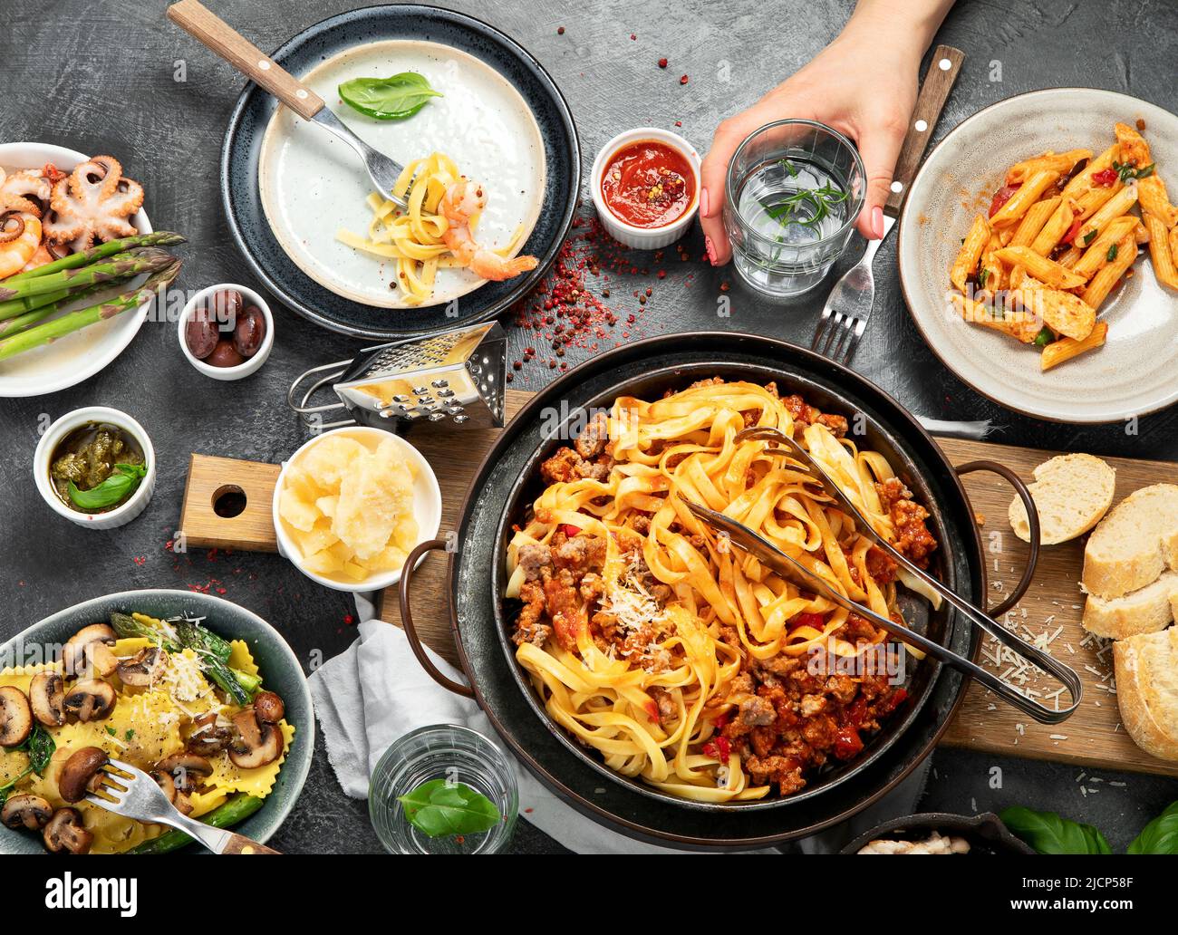 Table of italian meals on plates pasta Bolognese, ravioli, penne with ...