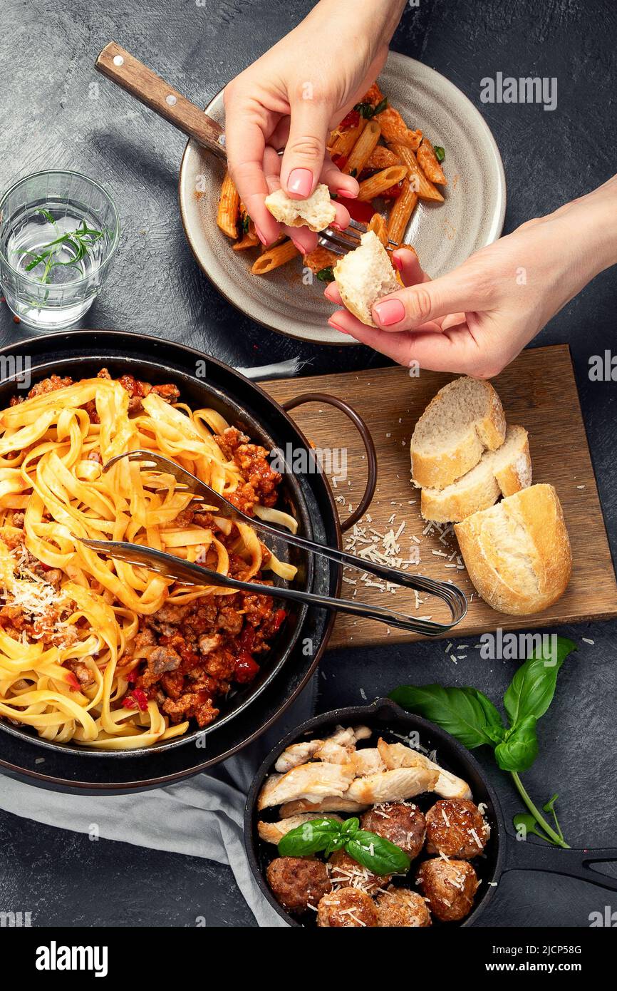 Table of italian meals on plates pasta Bolognese, ravioli, penne with ...