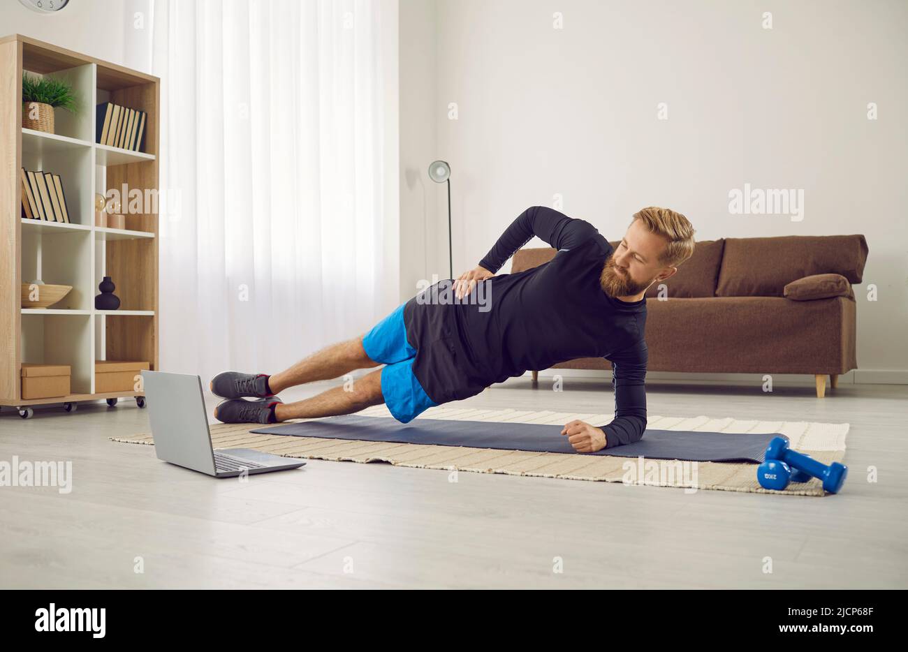 Fit man train at home with online lesson on computer Stock Photo - Alamy