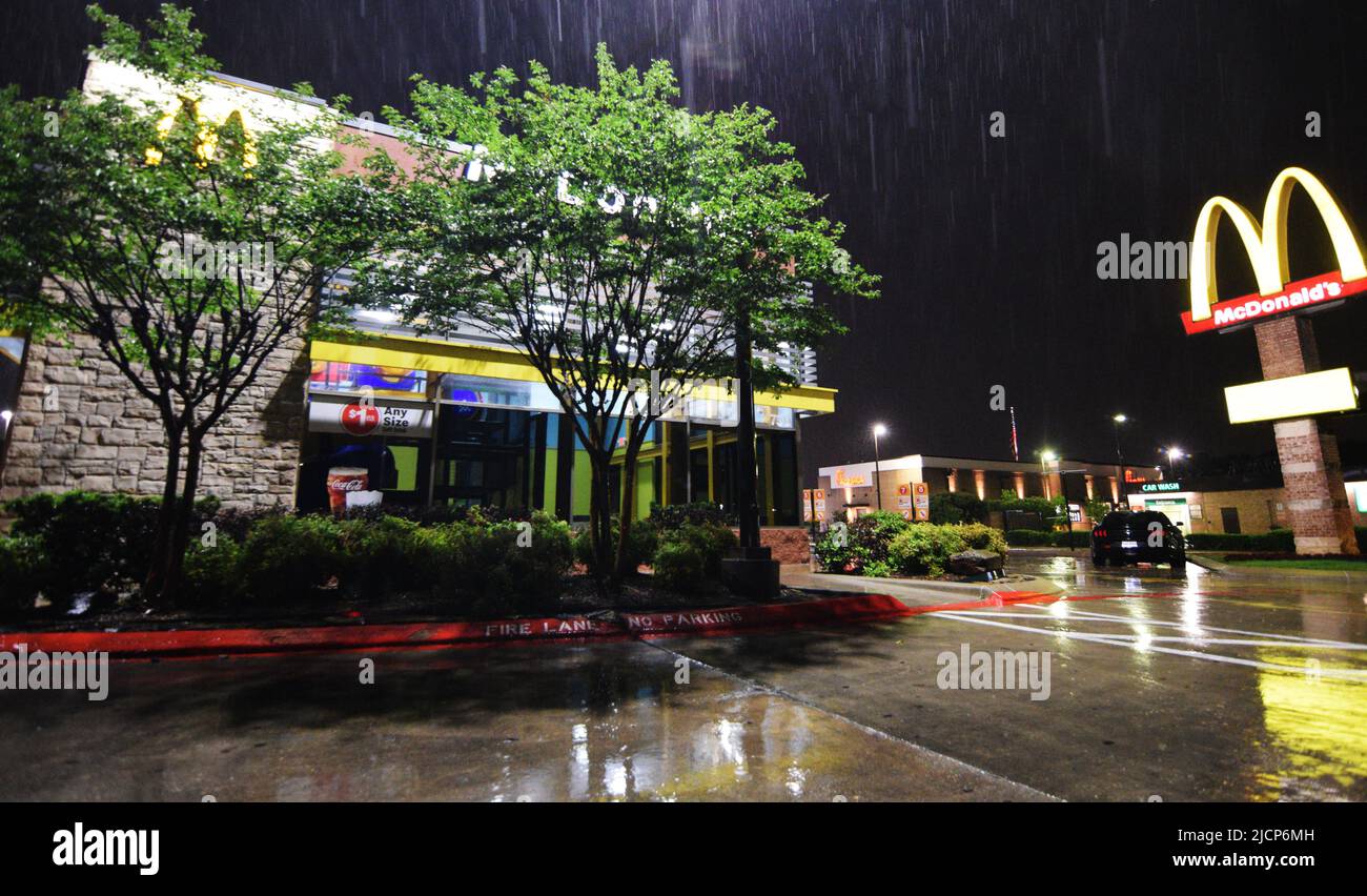 The lights of a McDonald's fast food restaurant refelct in a parking ...