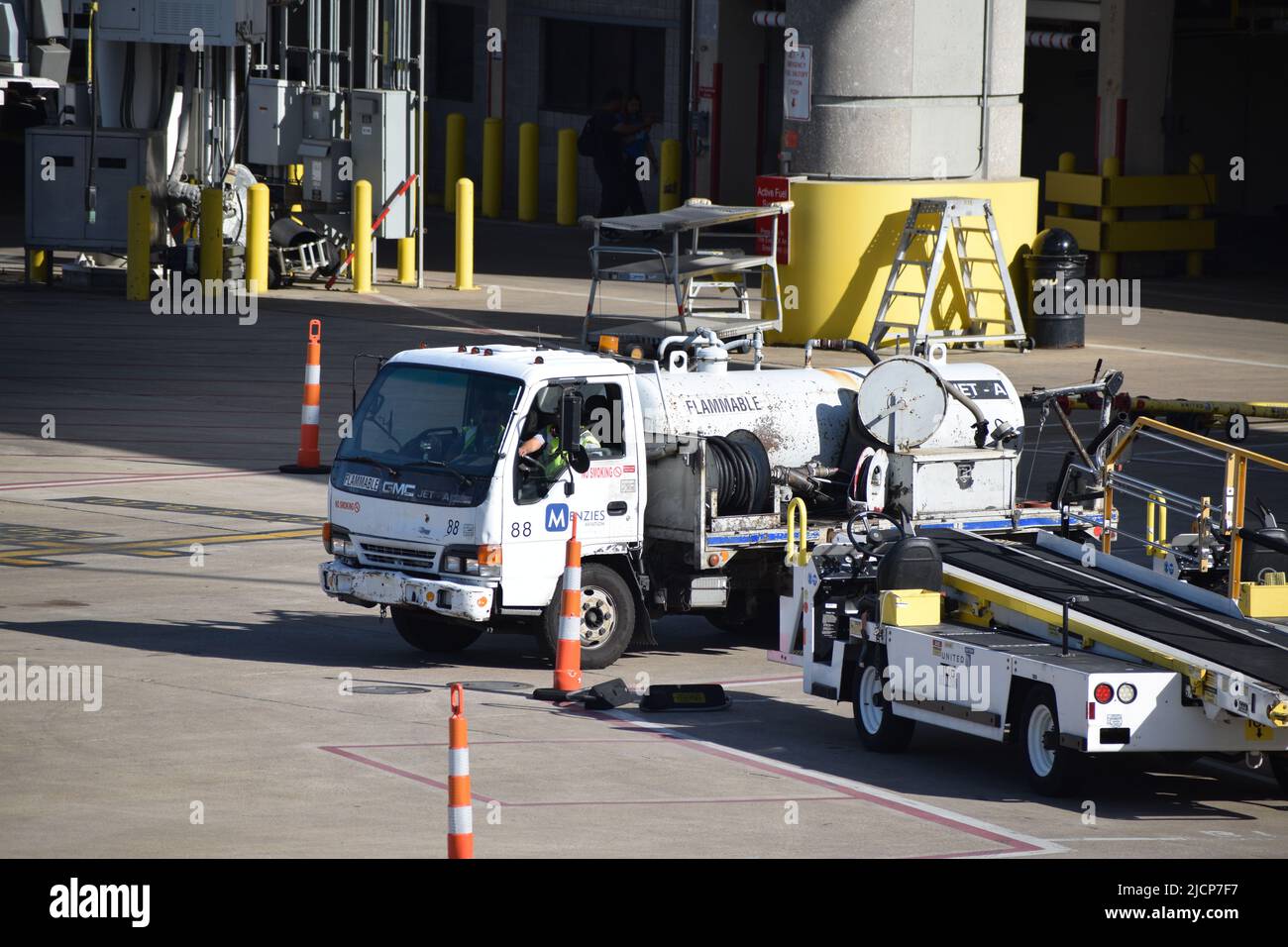 A Menzies Aviation truck delivering jet fuel outside Terminal E at ...