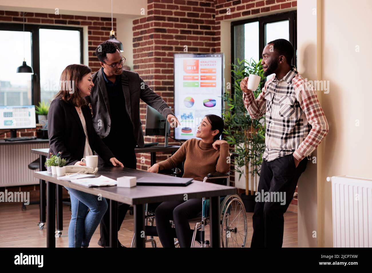 Business people meeting on break in disability friendly office ...