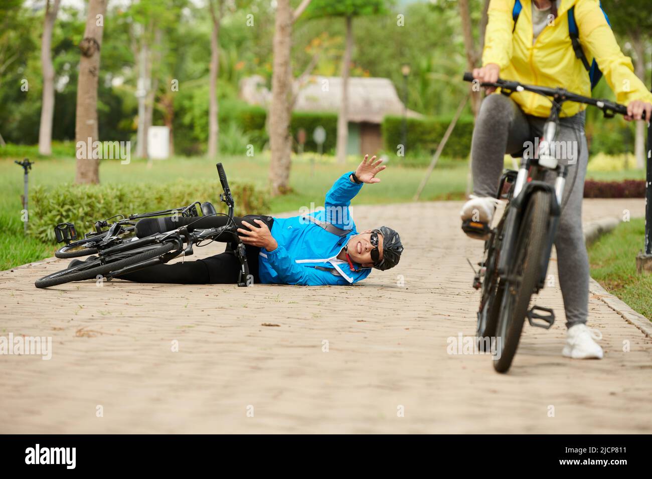 Man asking for help after falling from bicycle and injuring knee Stock ...