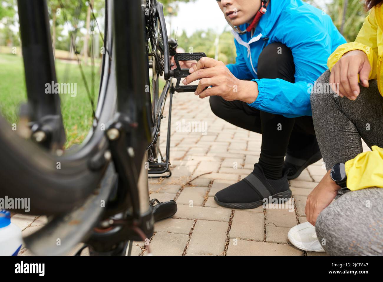 Man checking if bicycle pedals are spinning smoothly Stock Photo - Alamy