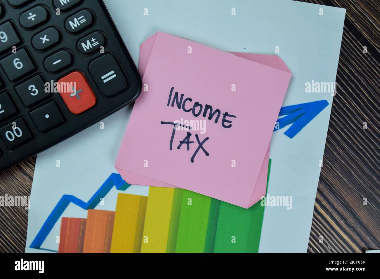 Concept of Income Tax write on sticky notes isolated on Wooden Table ...