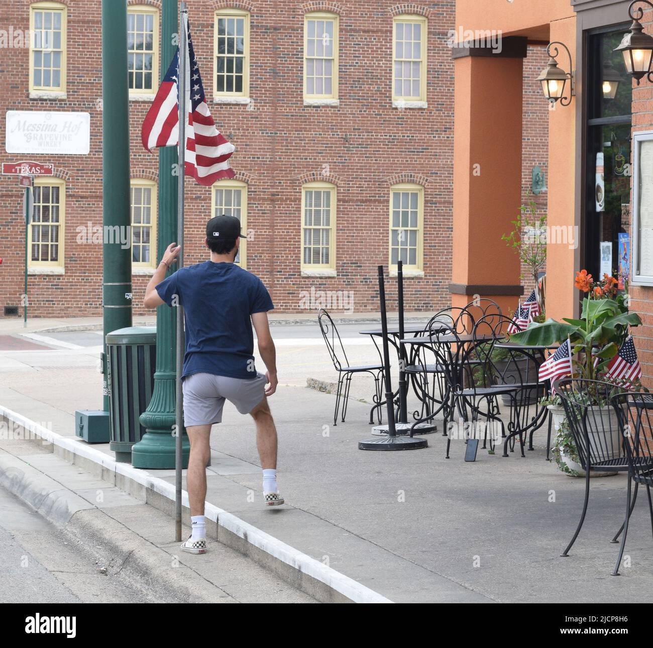 Young Gen Z man (Generation Z) poses for a timed photo with his cell ...