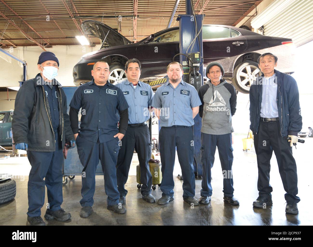 Group photo of mechanics working at a foreign auto repair shop in ...