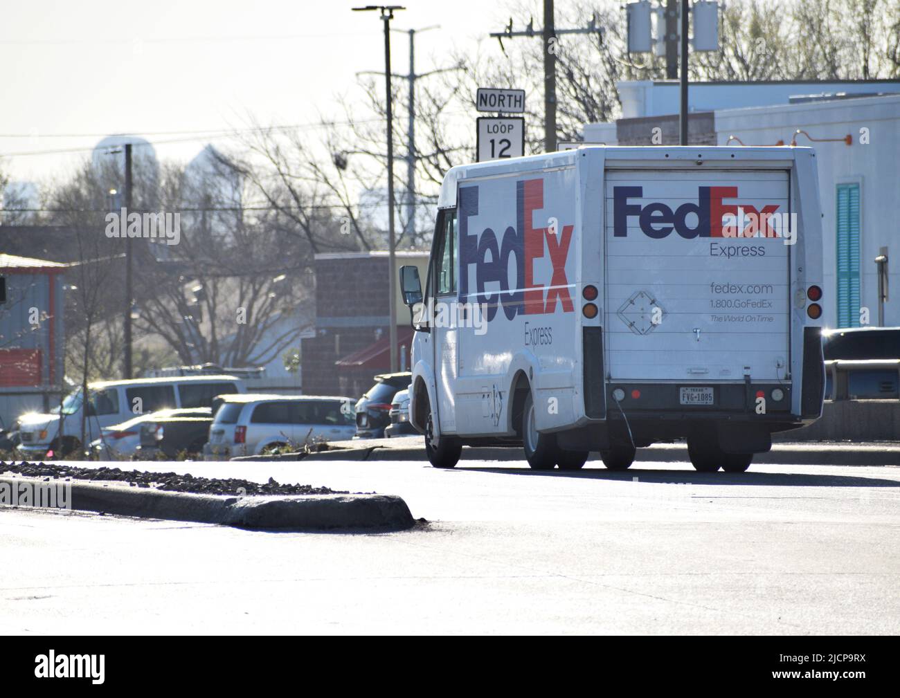 FedEx delivery truck driving, view moving away from the camera, facing ...