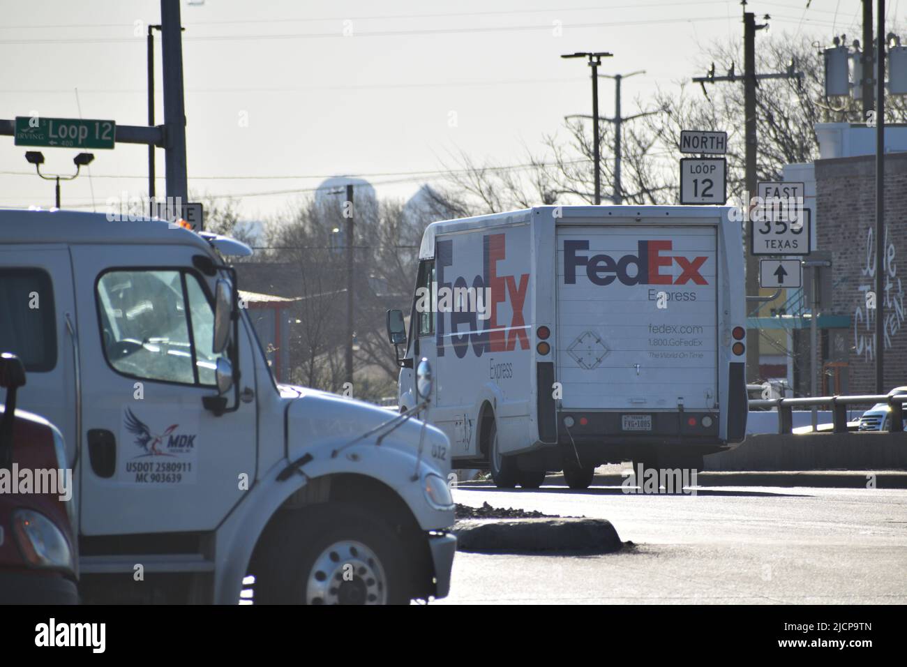FedEx delivery truck driving, view moving away from the camera, facing ...