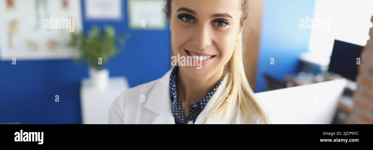 Cute medical worker or head doctor in uniform posing in clinic office ...