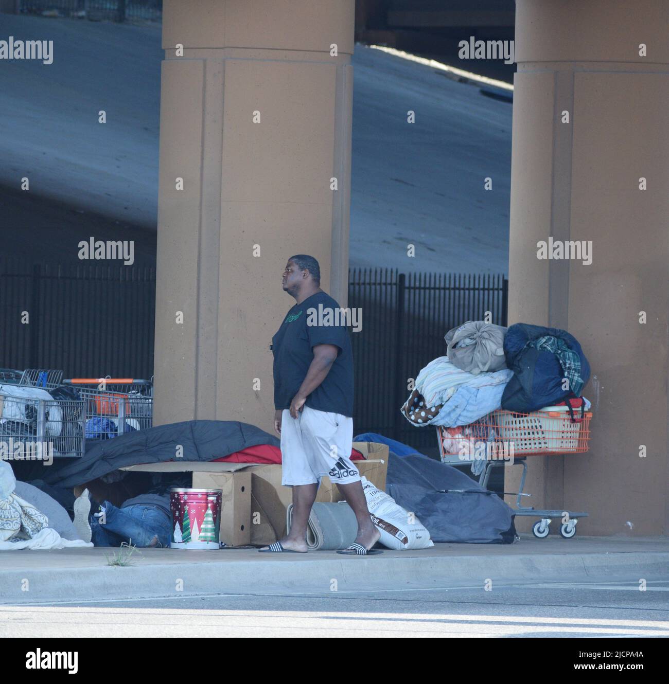 A homeless African American man with all of his belongings under a ...