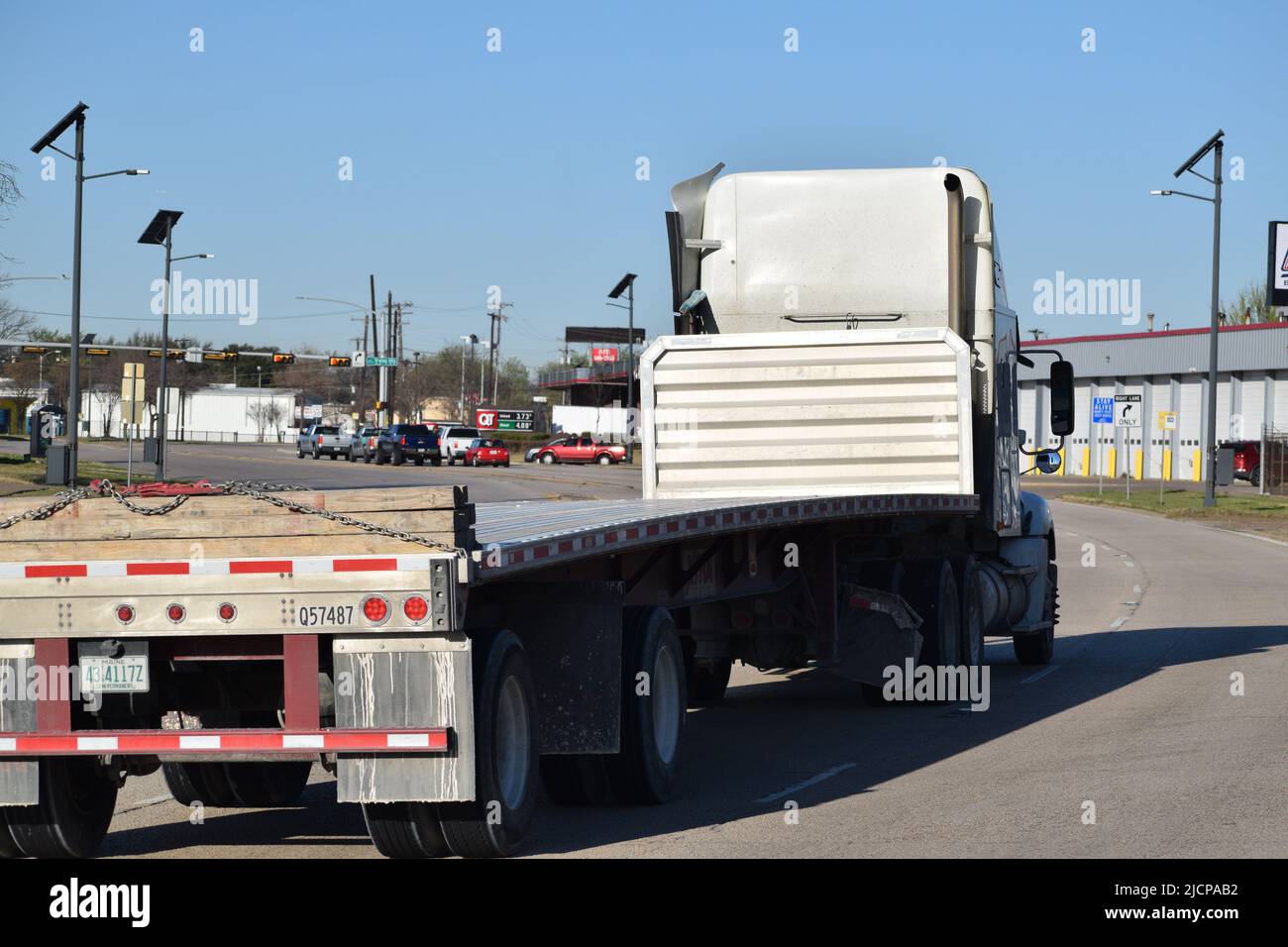 A semi-truck and empty flatbed trailer, facing right Stock Photo - Alamy