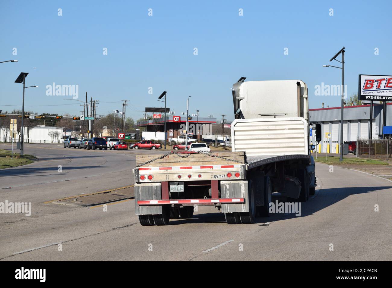 A semi-truck and empty flatbed trailer, facing right Stock Photo - Alamy