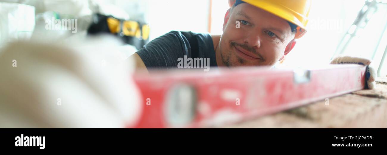 Pedantic man using level tool to measure height of brick wall Stock ...