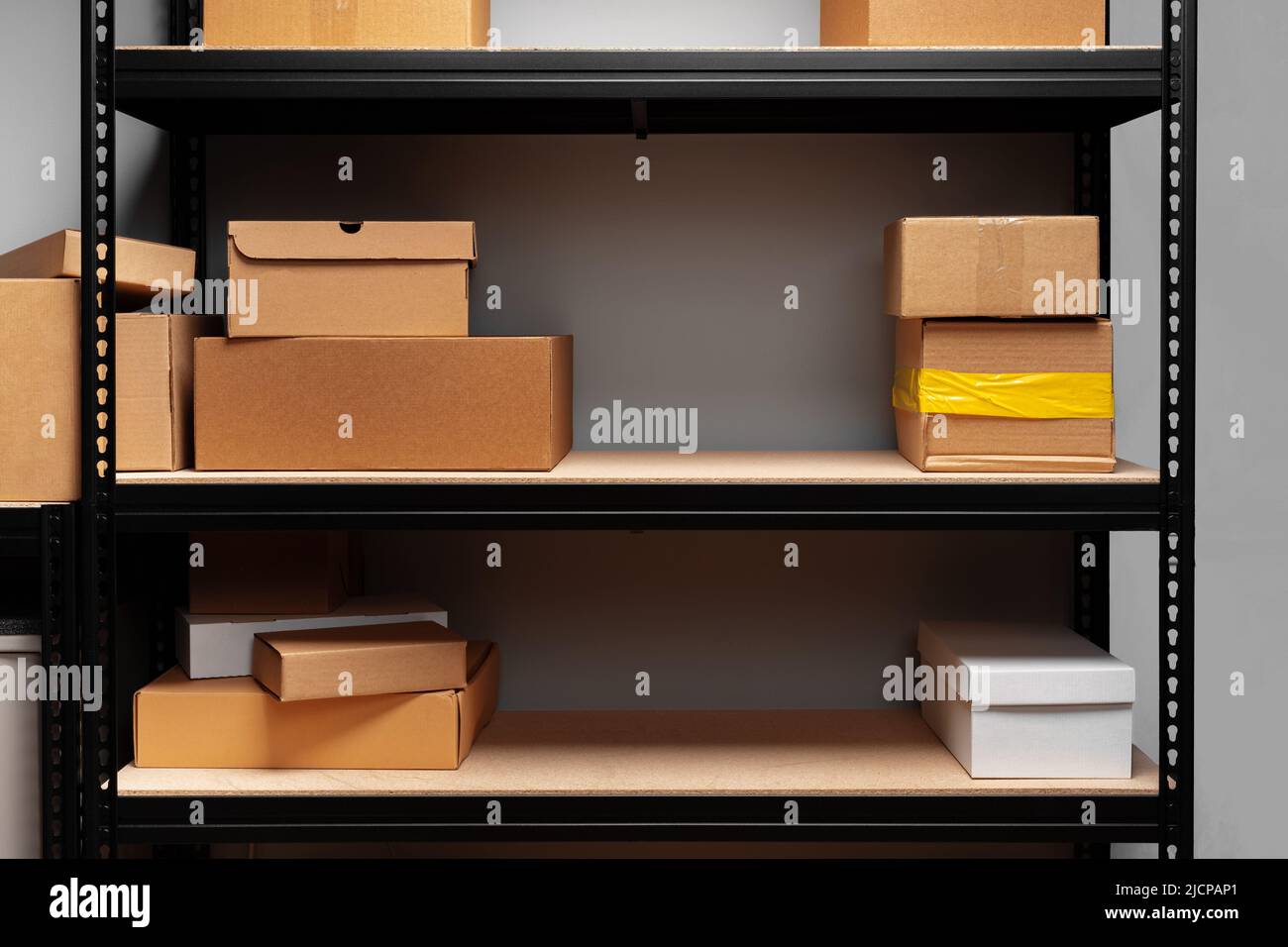 Rows of shelves with cardboard boxes in modern warehouse Stock Photo ...
