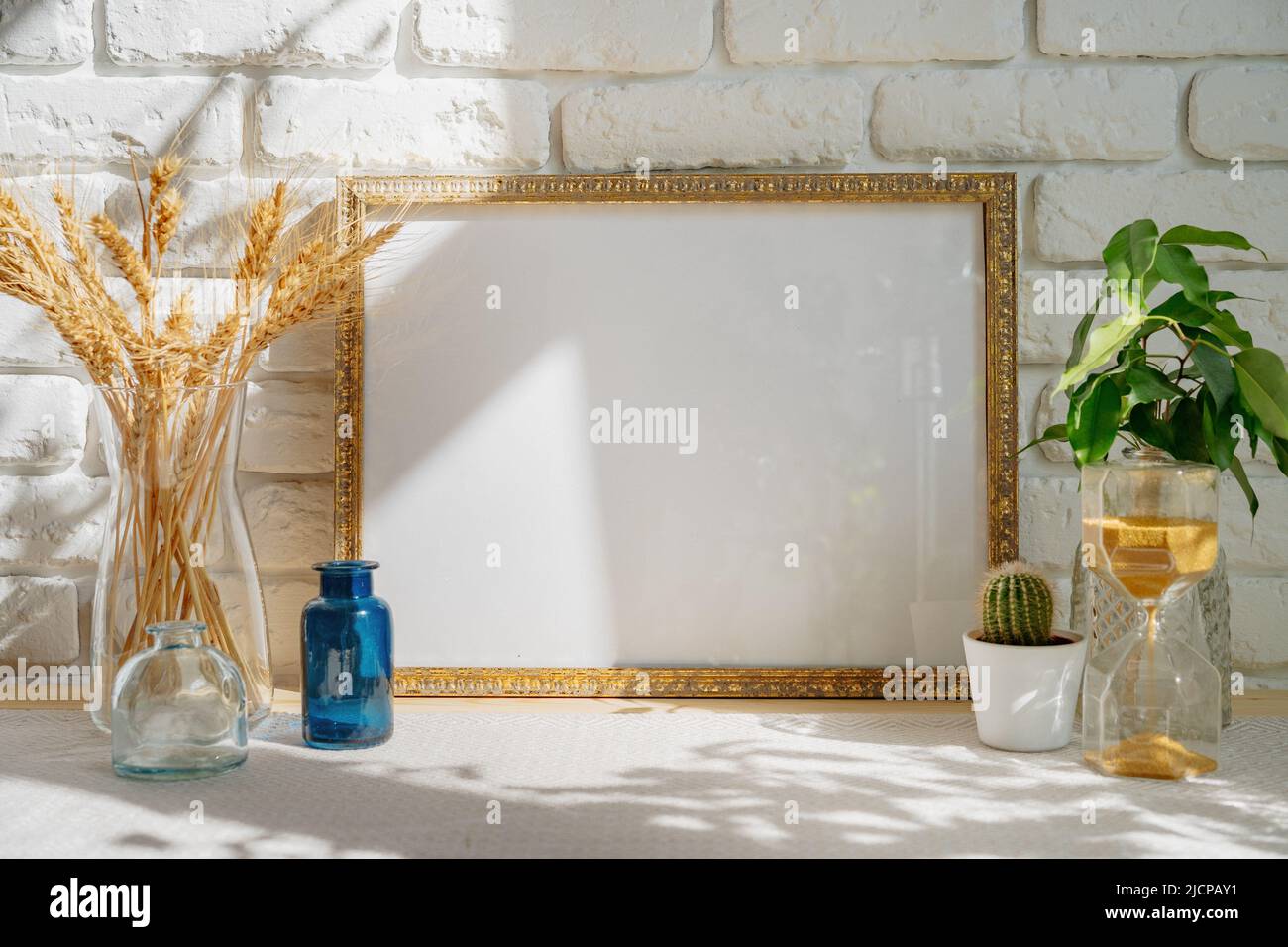 Photo frames on a brick wall background on the table with wheat ears in ...