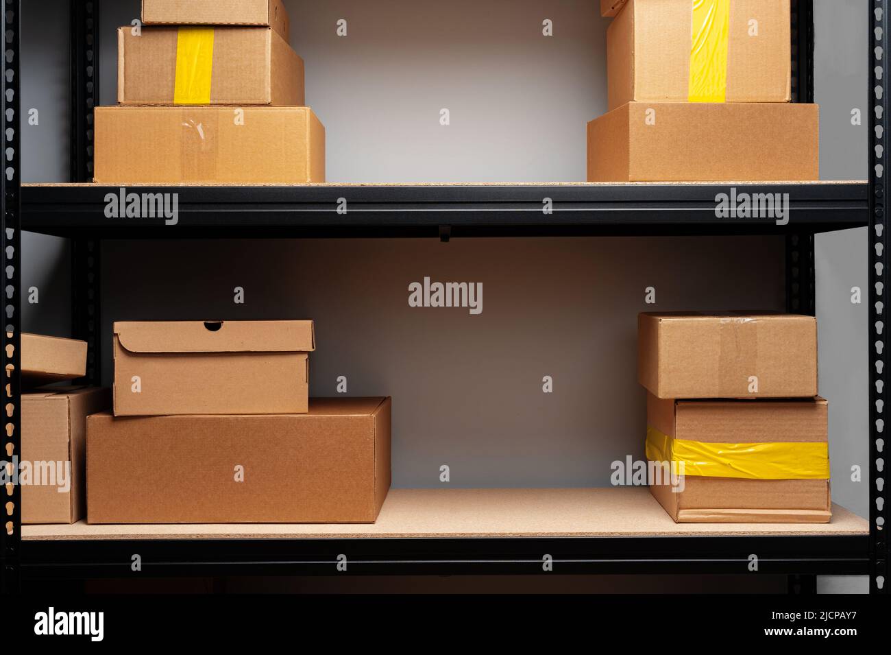 Rows of shelves with cardboard boxes in modern warehouse Stock Photo ...